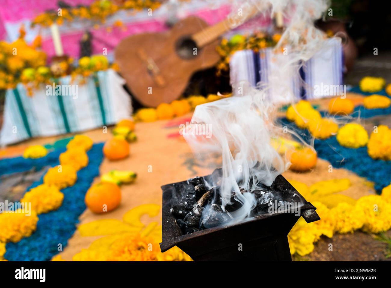 An incense burner is seen smoking at the altar of the dead (Altar de ...