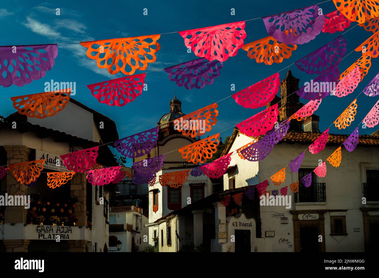 Pecked paper flags are hung over the colonial plaza during the Day of ...