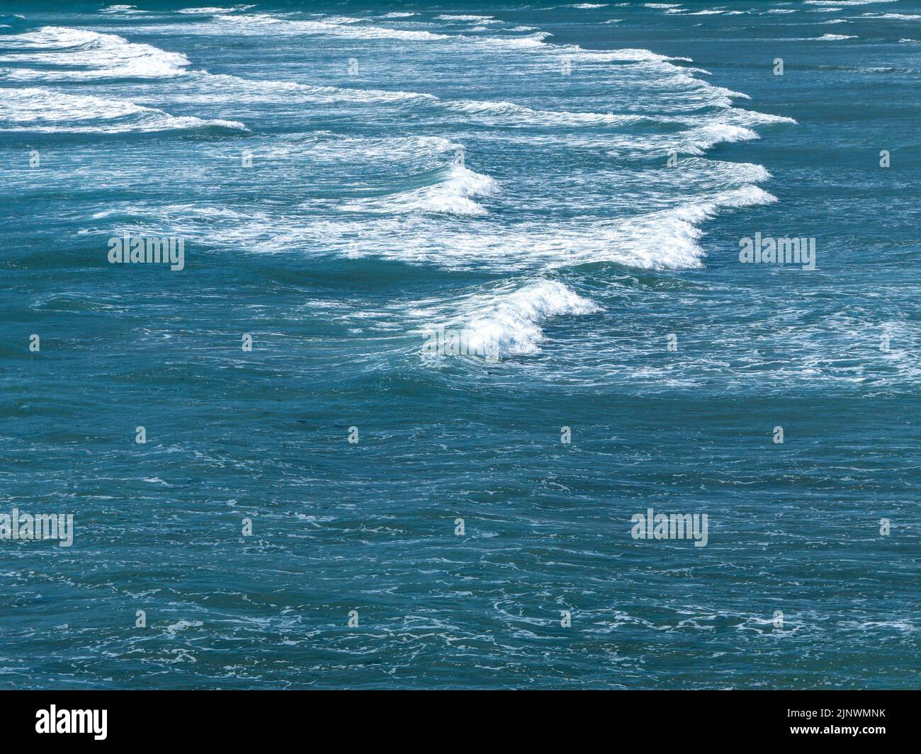 Beautiful foam on turquoise tidal waves. The surface of the water as a ...