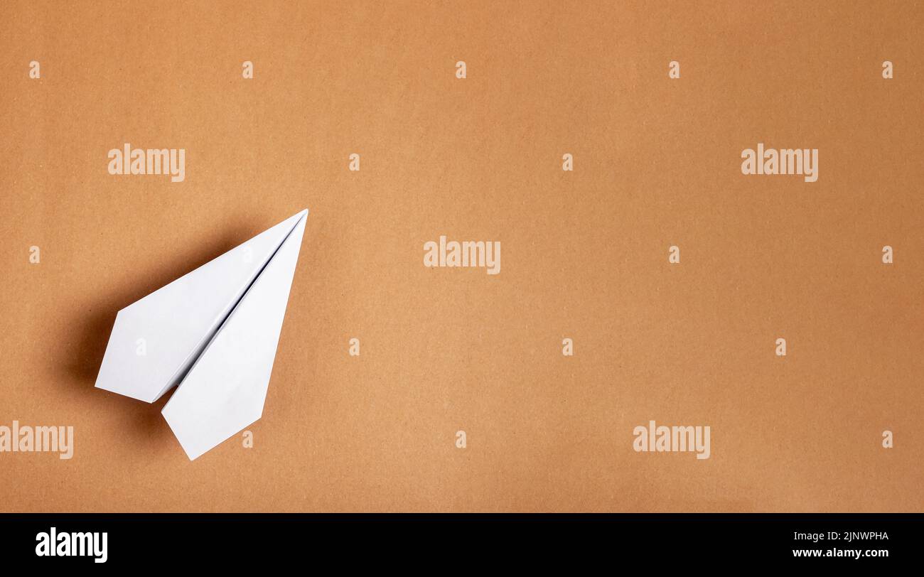 Paper plane on kraft brown background with copy space. High quality ...