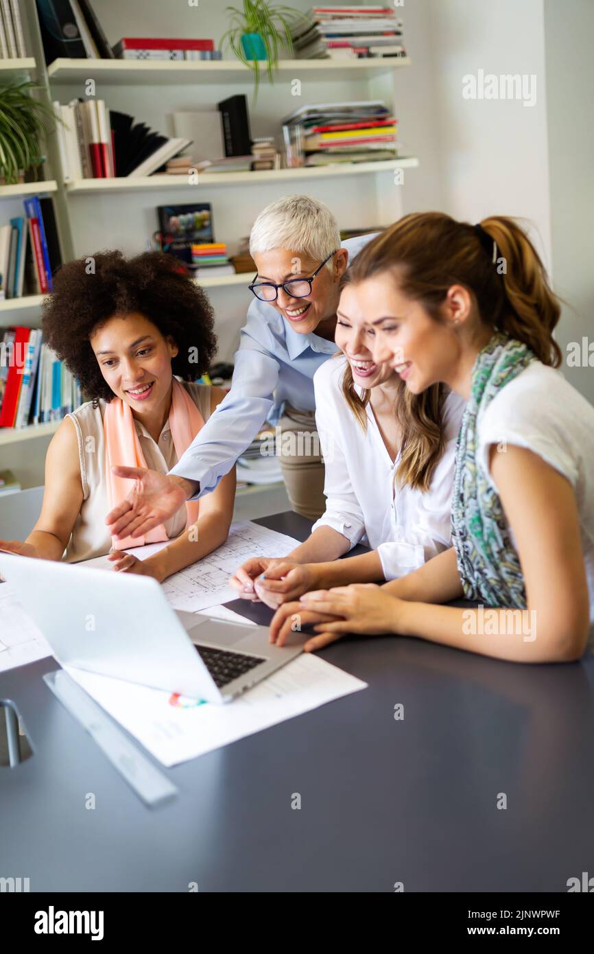 Group of happy successful women colleagues working together on meeting ...