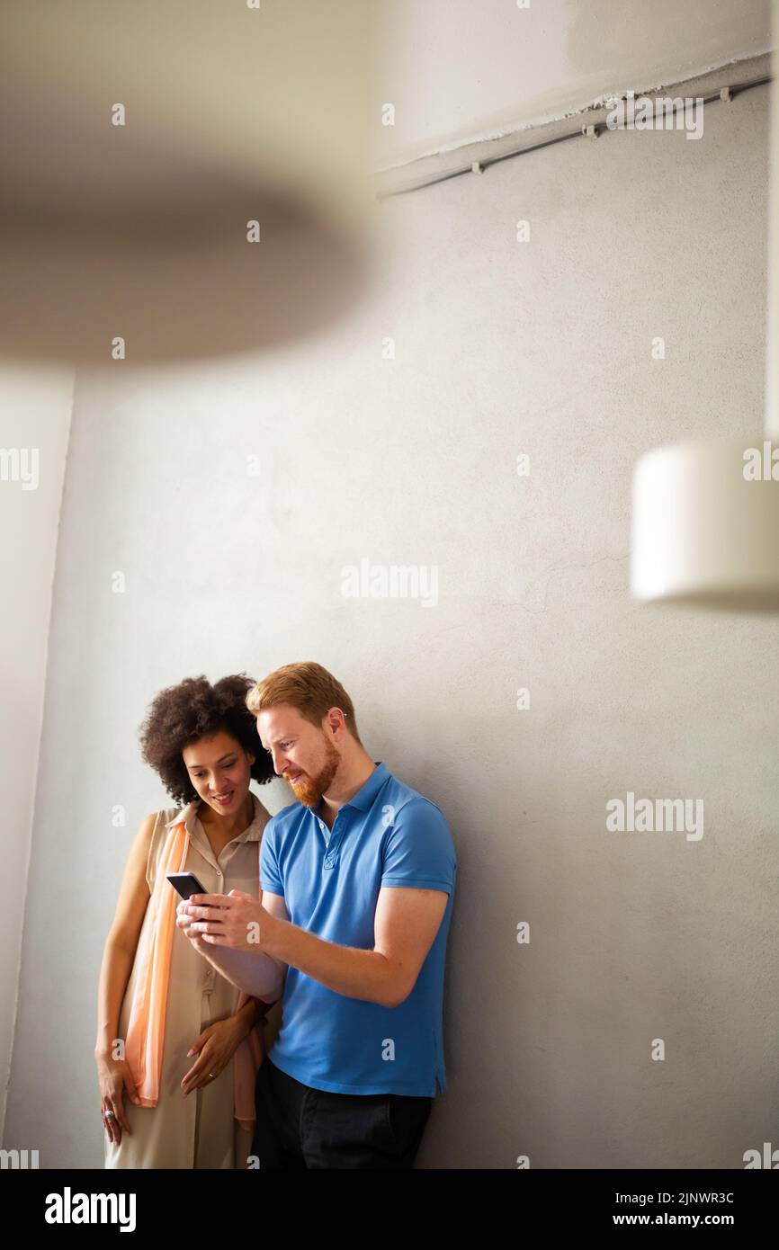 Happy business people having fun and chatting at workplace office ...