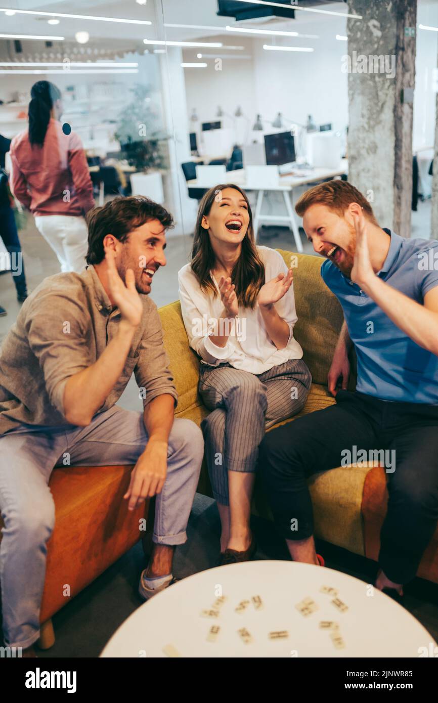 Group of happy multiethnic business people having fun and chatting at ...