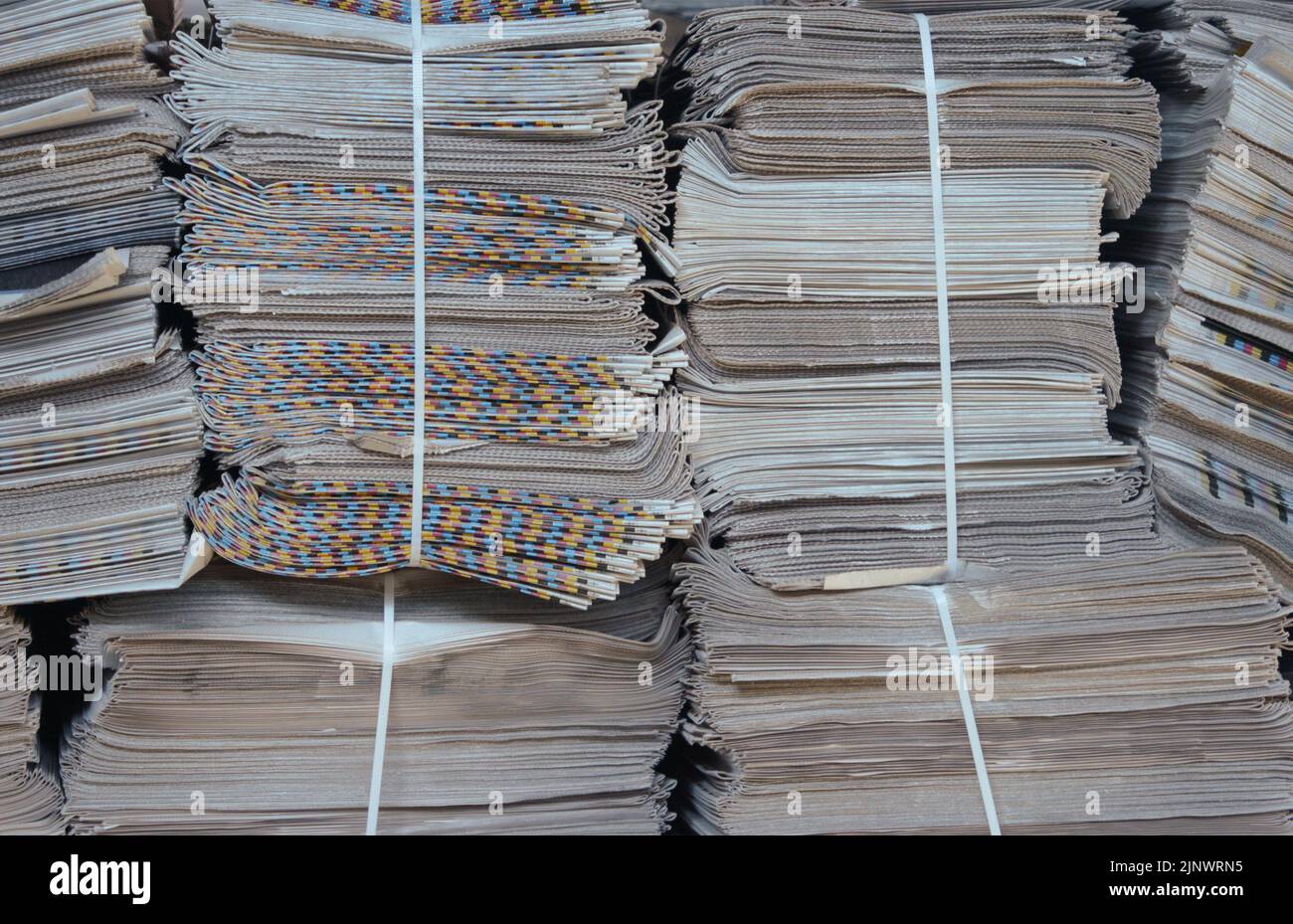 Front view of many stacks of newspapers Stock Photo - Alamy