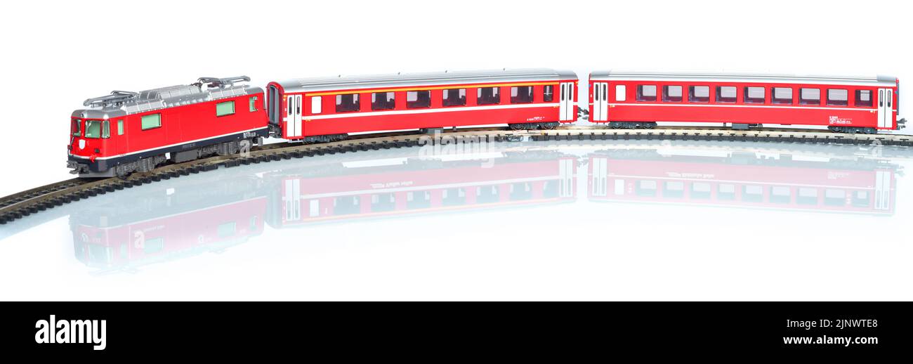 Scale toy model of red train isolated on white reflective background ...