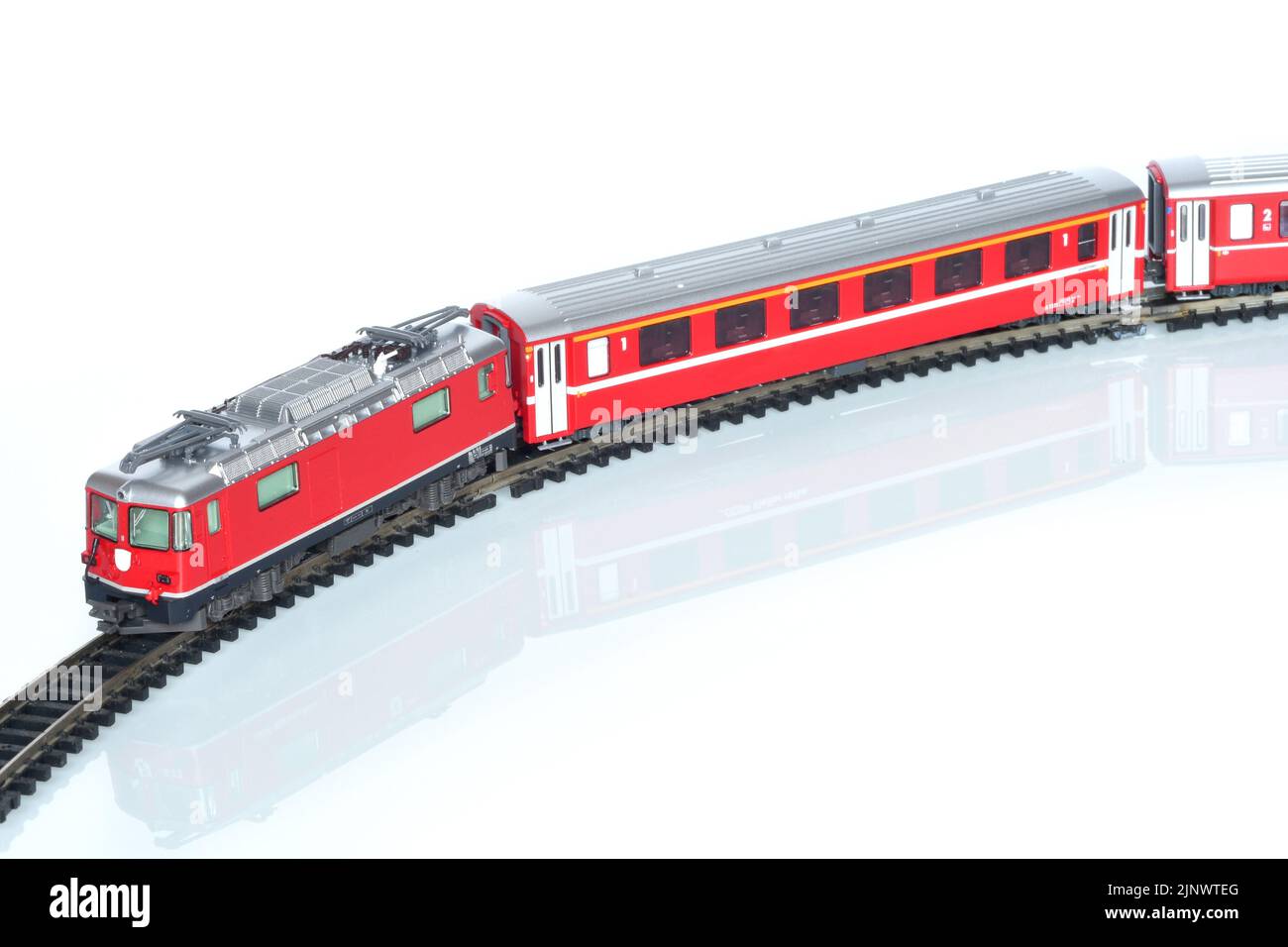 Scale toy model of red train isolated on white reflective background ...
