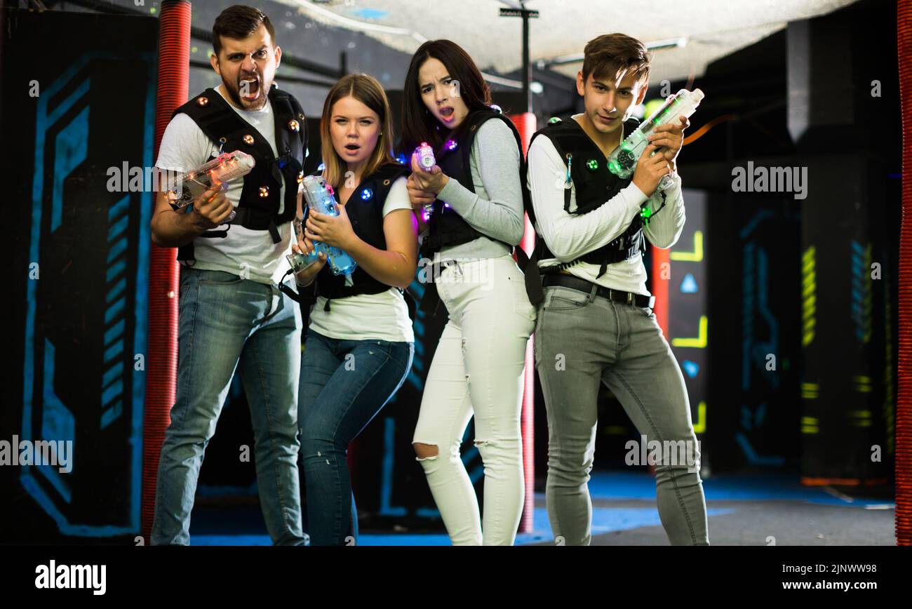 Young people in laser tag labyrinth Stock Photo - Alamy