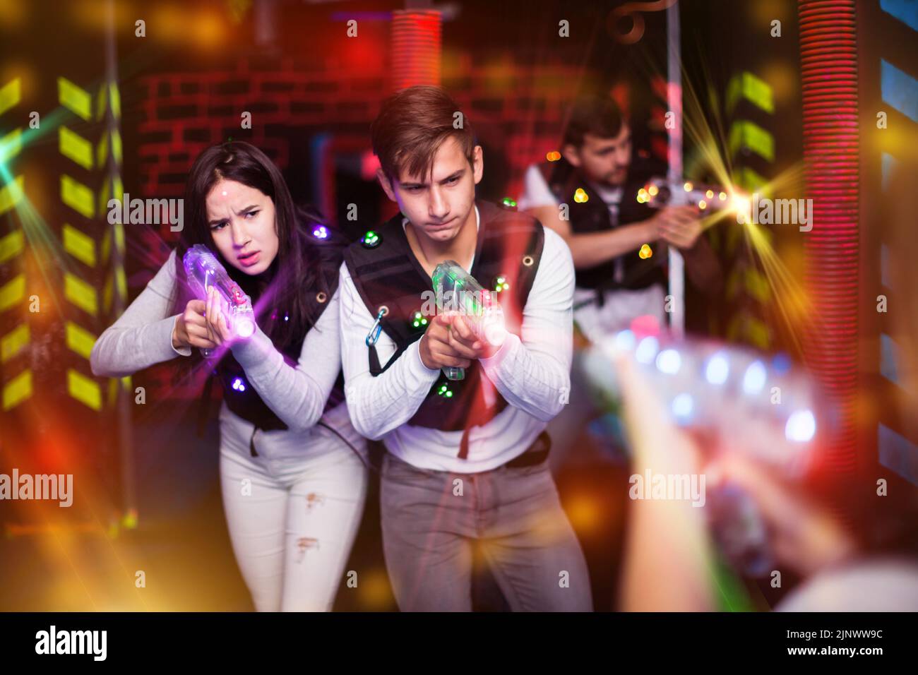 Couple playing laser tag Stock Photo - Alamy
