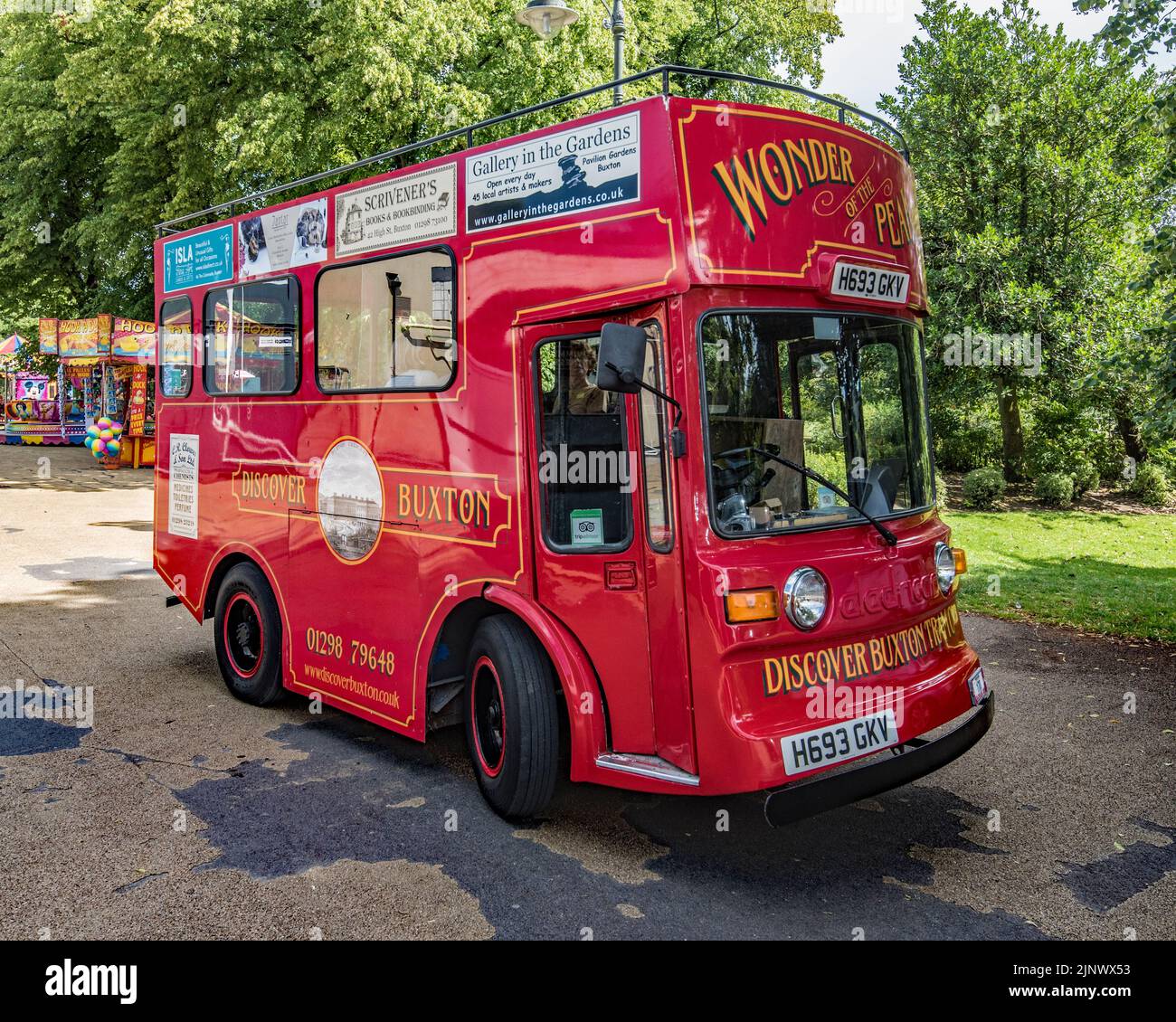 Discover Buxton in a small red open-topped tourist bus Stock Photo - Alamy