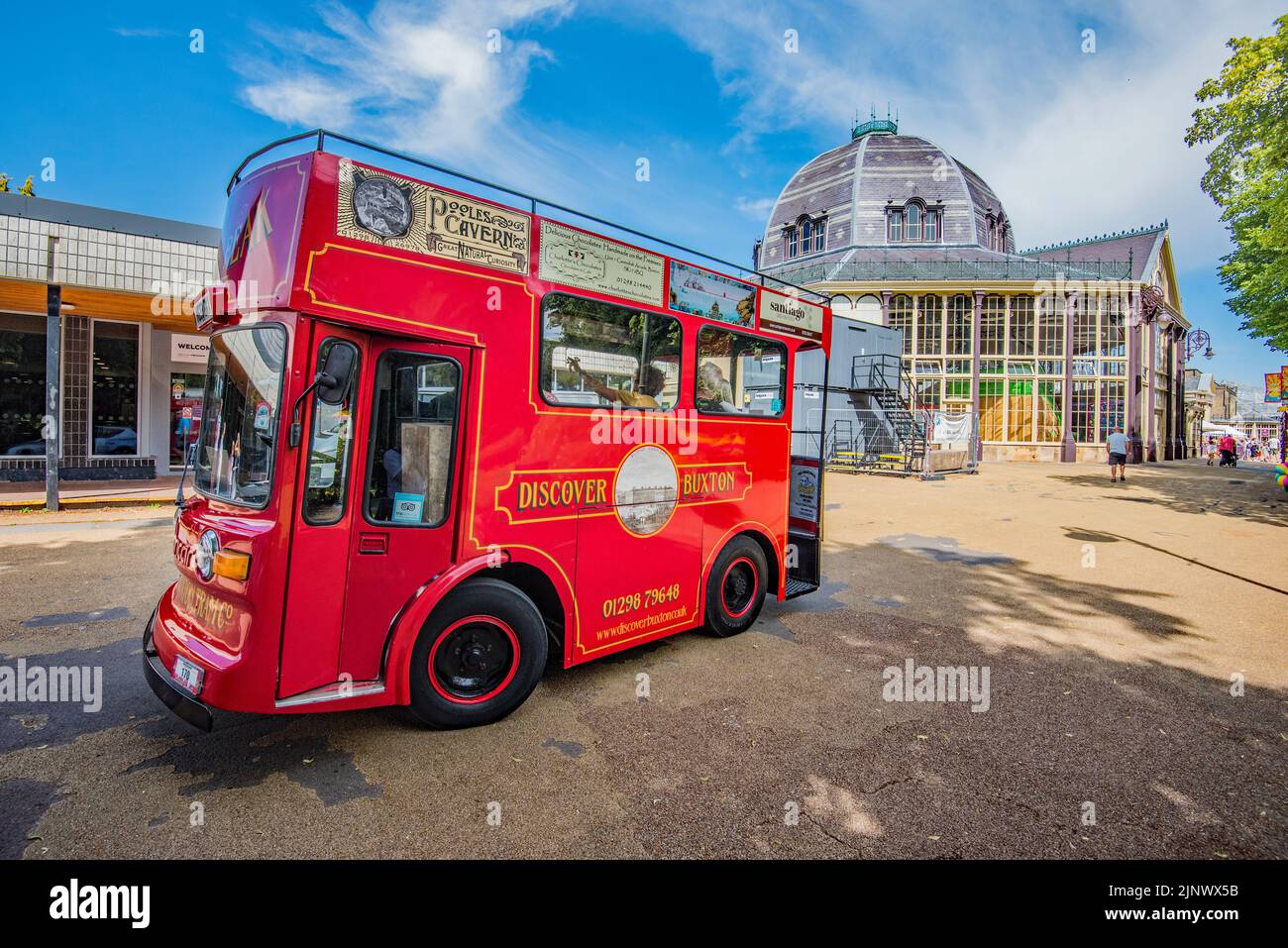 The open-topped red tour bus to Discover Buxton is parked close by to ...