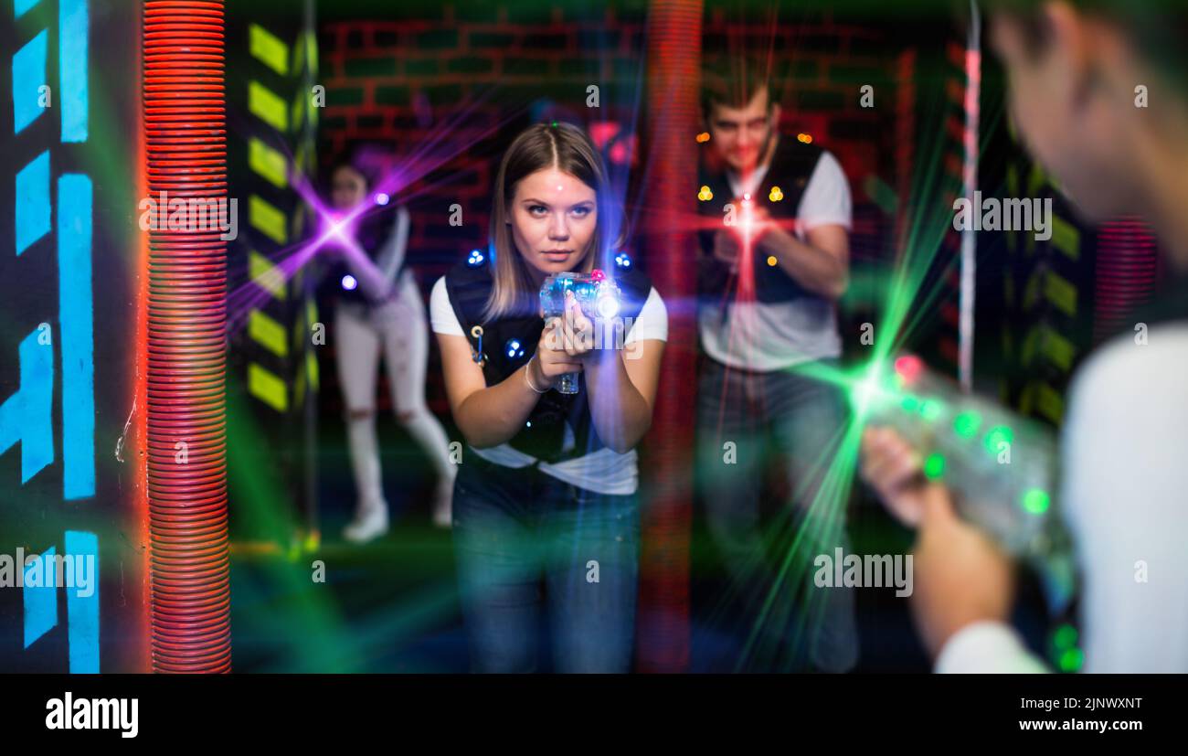 Girl playing laser tag in colorful beams Stock Photo - Alamy