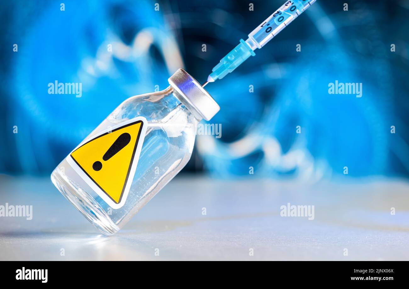 Vaccine bottle with yellow triangle exclamation mark sign on label ...