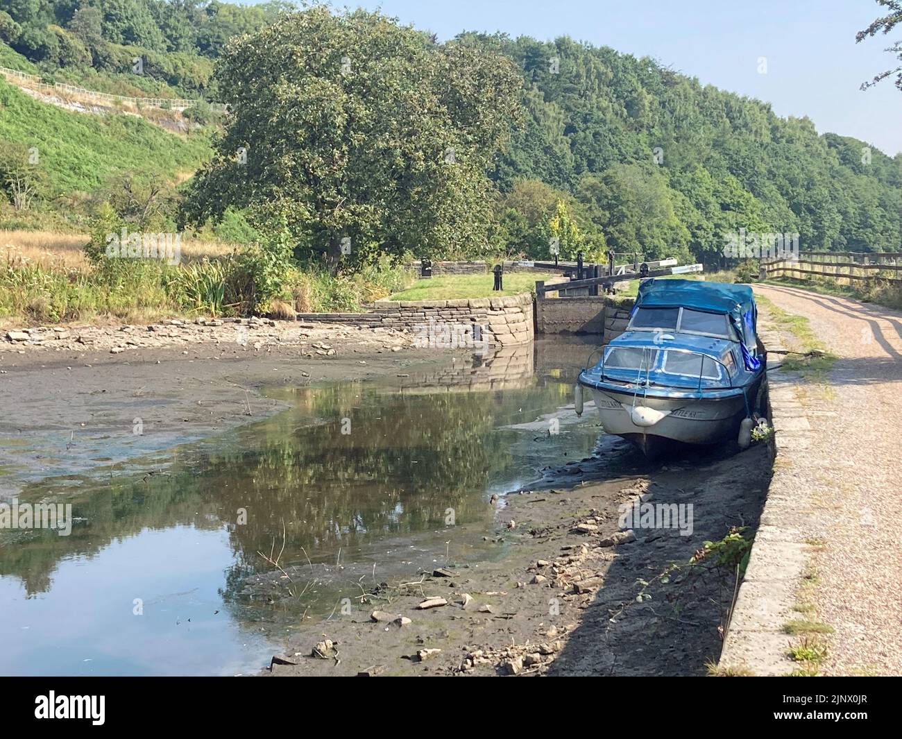 A boat lies in the dried up Huddersfield narrow canal near Linthwaite ...