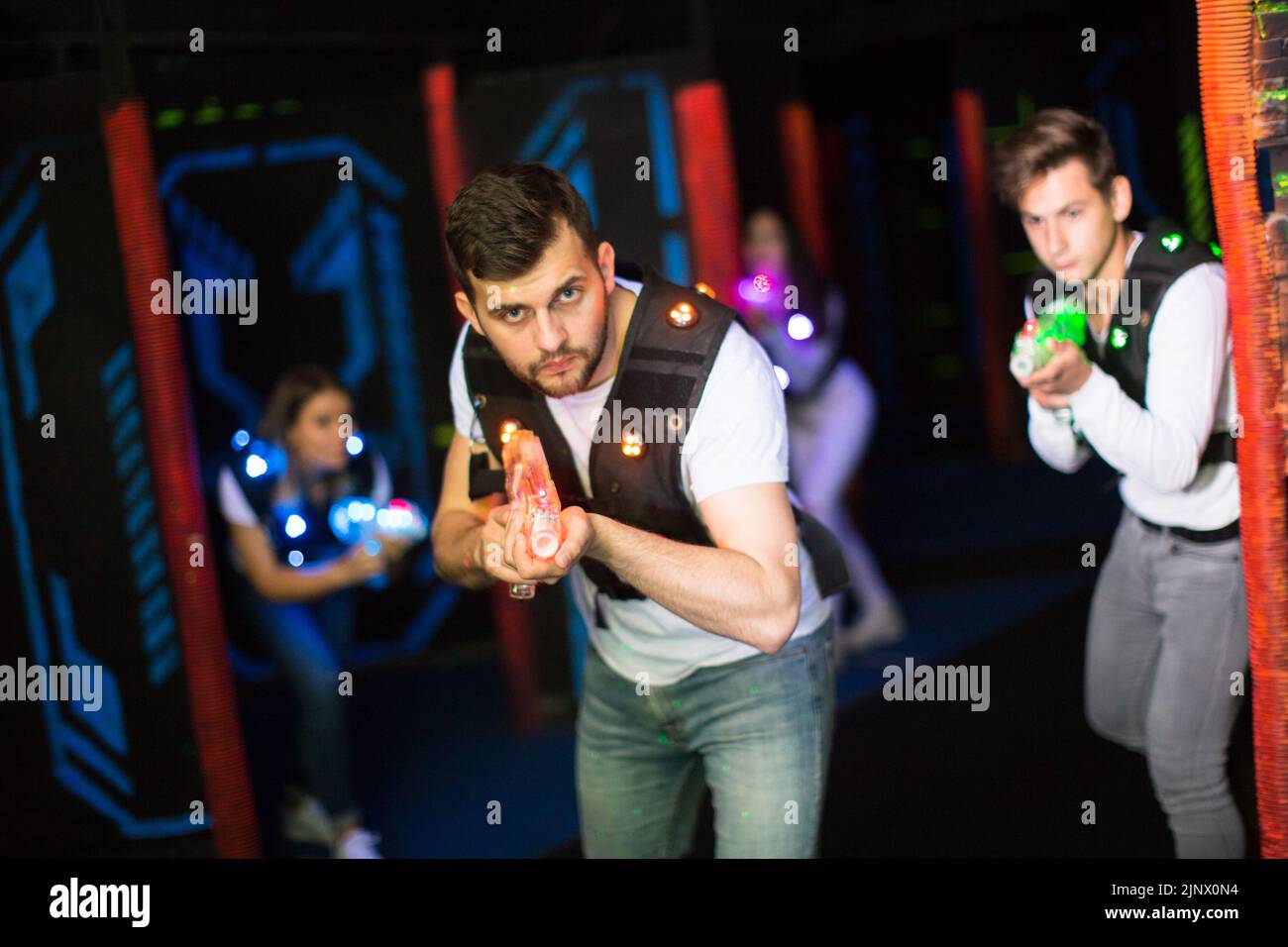 Emotional guy playing laser tag Stock Photo - Alamy