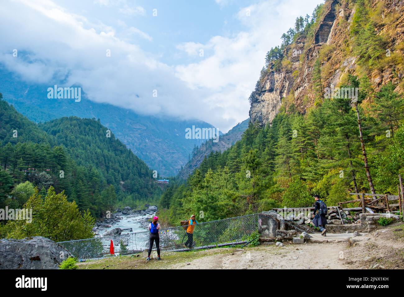 Phakding, Nepal - 22 Apr 2022: people walking near a river from Everest ...