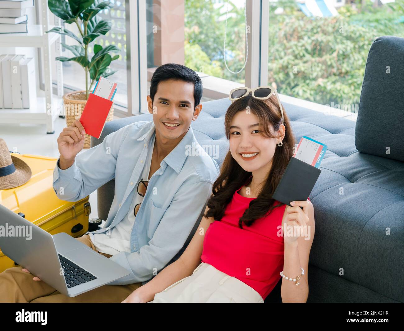 Happy Asian couple ready to trip, young man and woman, holding and ...