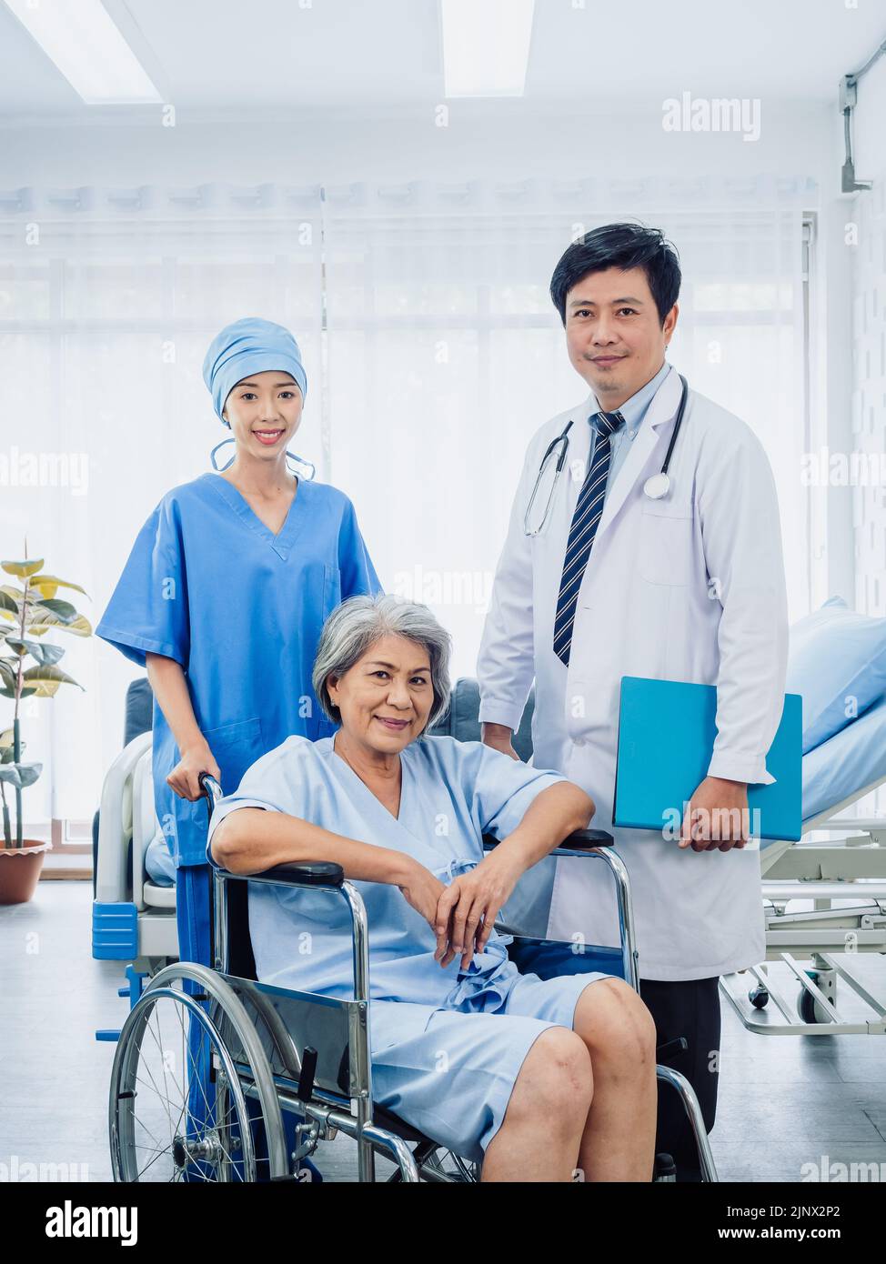 Male surgeon doctors and professional female nursing assistants take ...