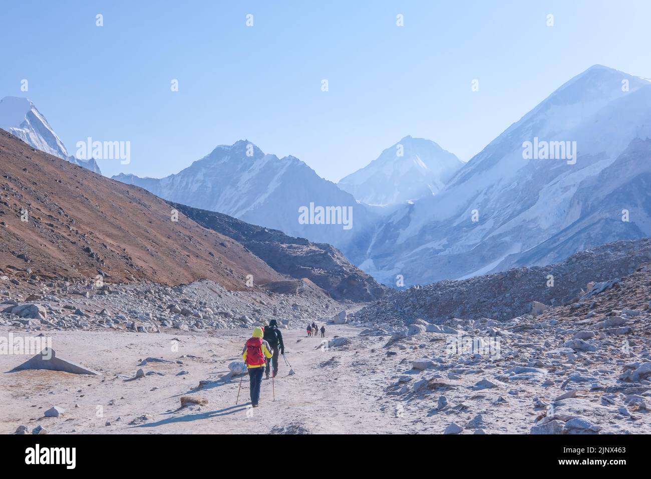 Tourist and porters walking on dirt road in Nepal to Everest Base Camp ...