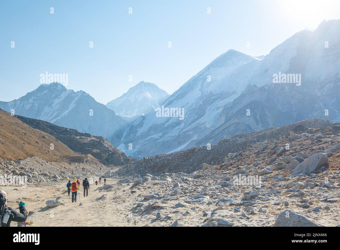 Tourist and porters walking on dirt road in Nepal to Everest Base Camp ...