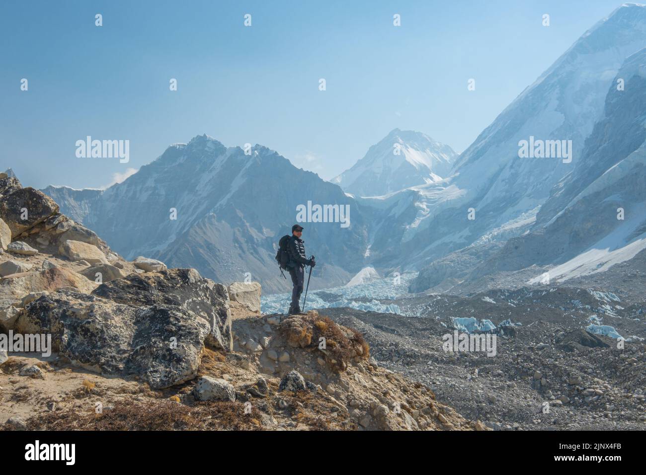 Male backpacker enjoying the view on mountain walk in Himalayas. Everest Base Camp trail route ...