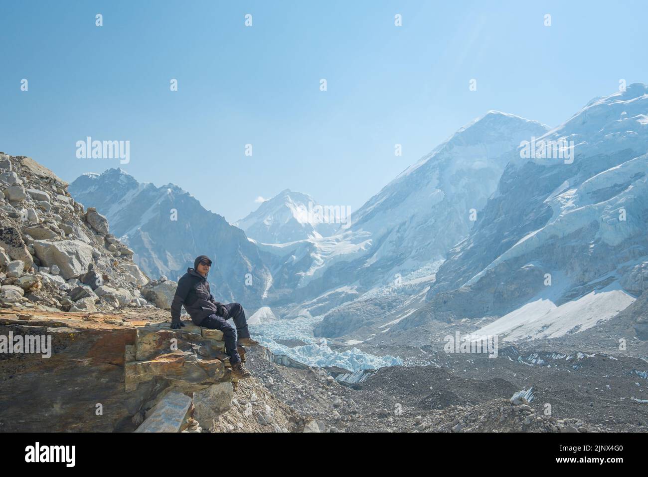 Male backpacker enjoying the view on mountain walk in Himalayas. Everest Base Camp trail route ...
