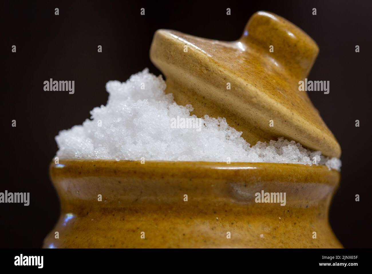 Granulated sea salt in an earthen jar. Common salt stored in jar used ...