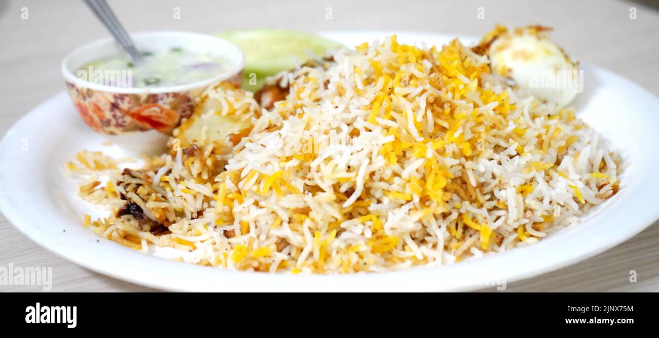 Special Kolkata Chicken Biryani Served With Raita Stock Photo - Alamy