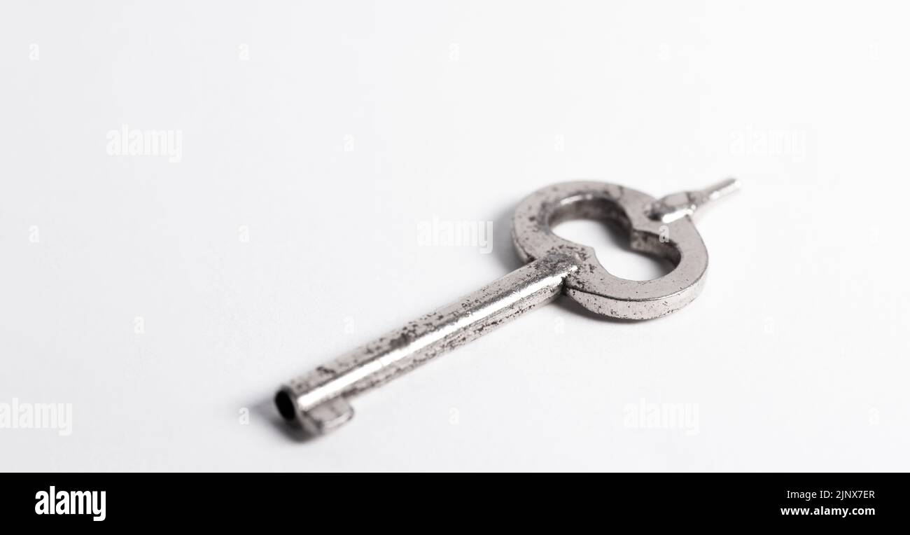 A police handcuff key isolated on a white background. Key to freedom ...