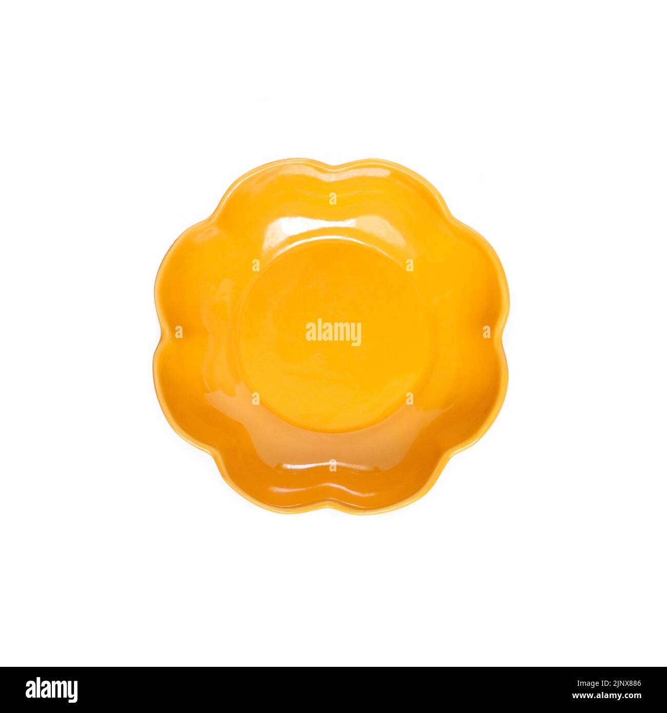 Yellow ceramic plate isolated on white background. Flat lay, top view ...