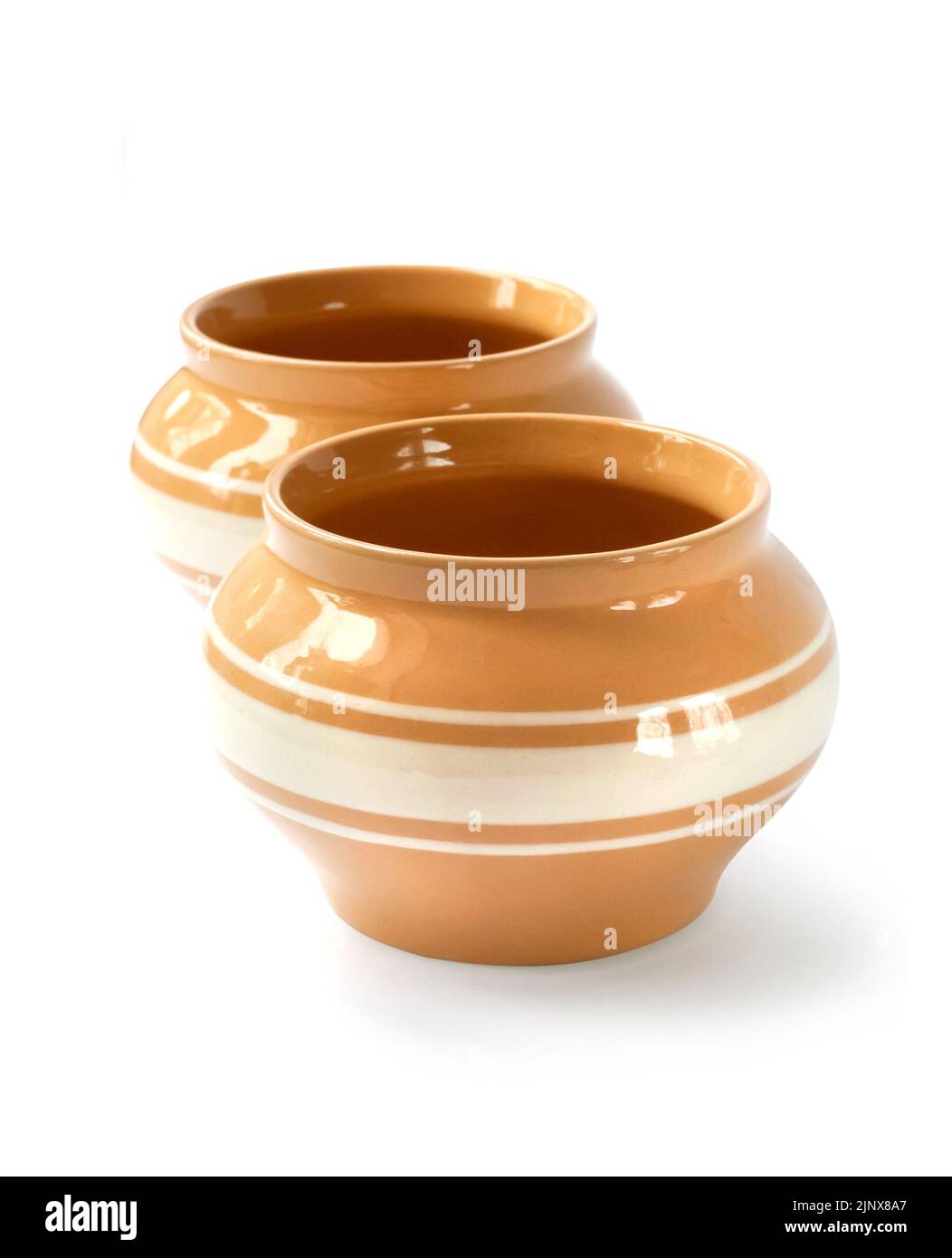Glazed ceramic pot for cooking on a white background with clipping path ...