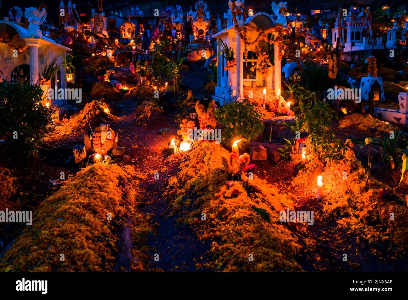 Tombs and graves are seen illuminated by burning candles during the Day ...