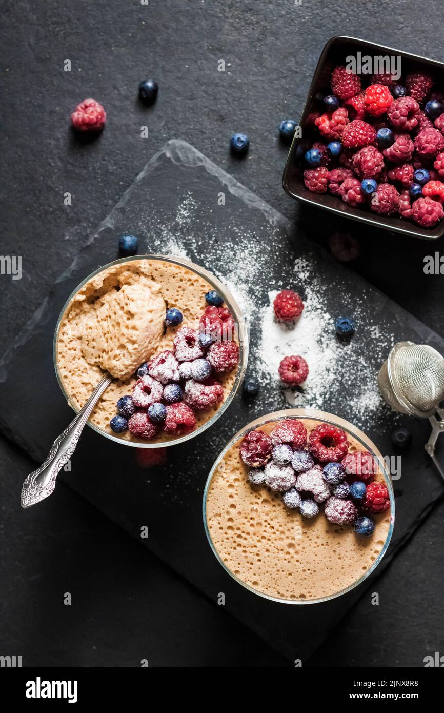 Ryazhenka (fermented baked milk) mousse in glass bowls decorated with ...