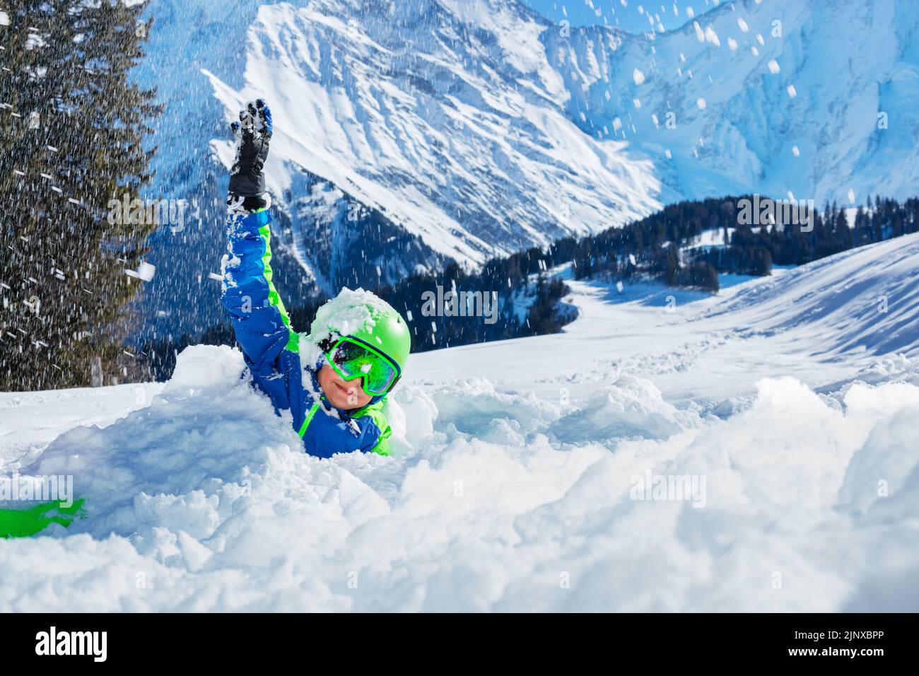 Fun with snow - happy boy play laying in snowdrift Stock Photo - Alamy
