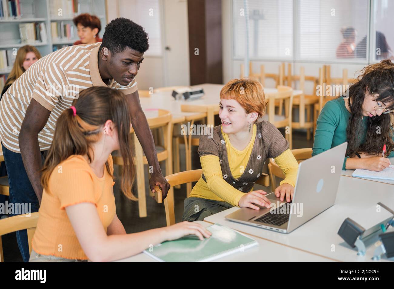 Group of students of different ethnicity in the university library ...