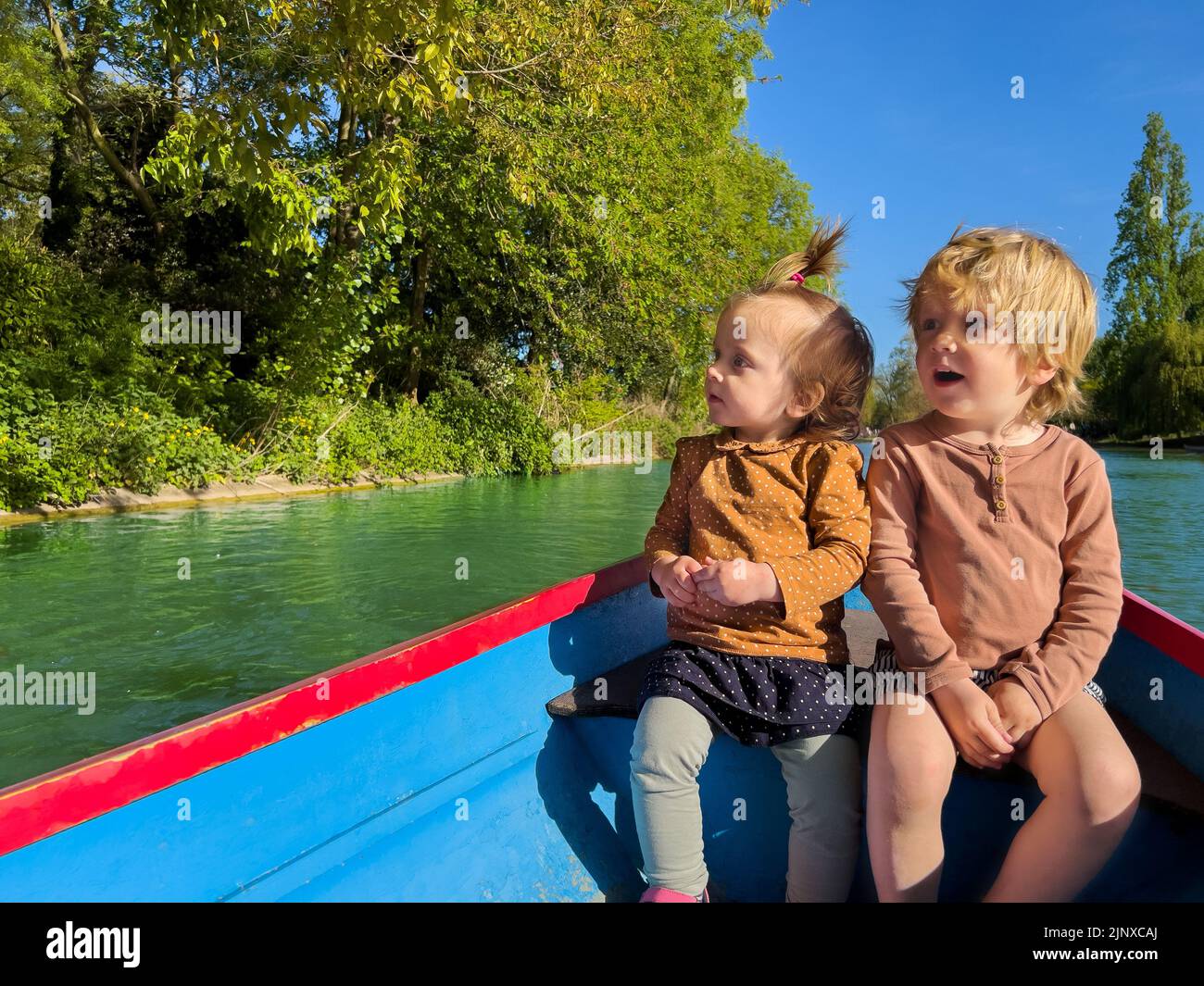Two charming little children in the small paddle river boat Stock Photo ...