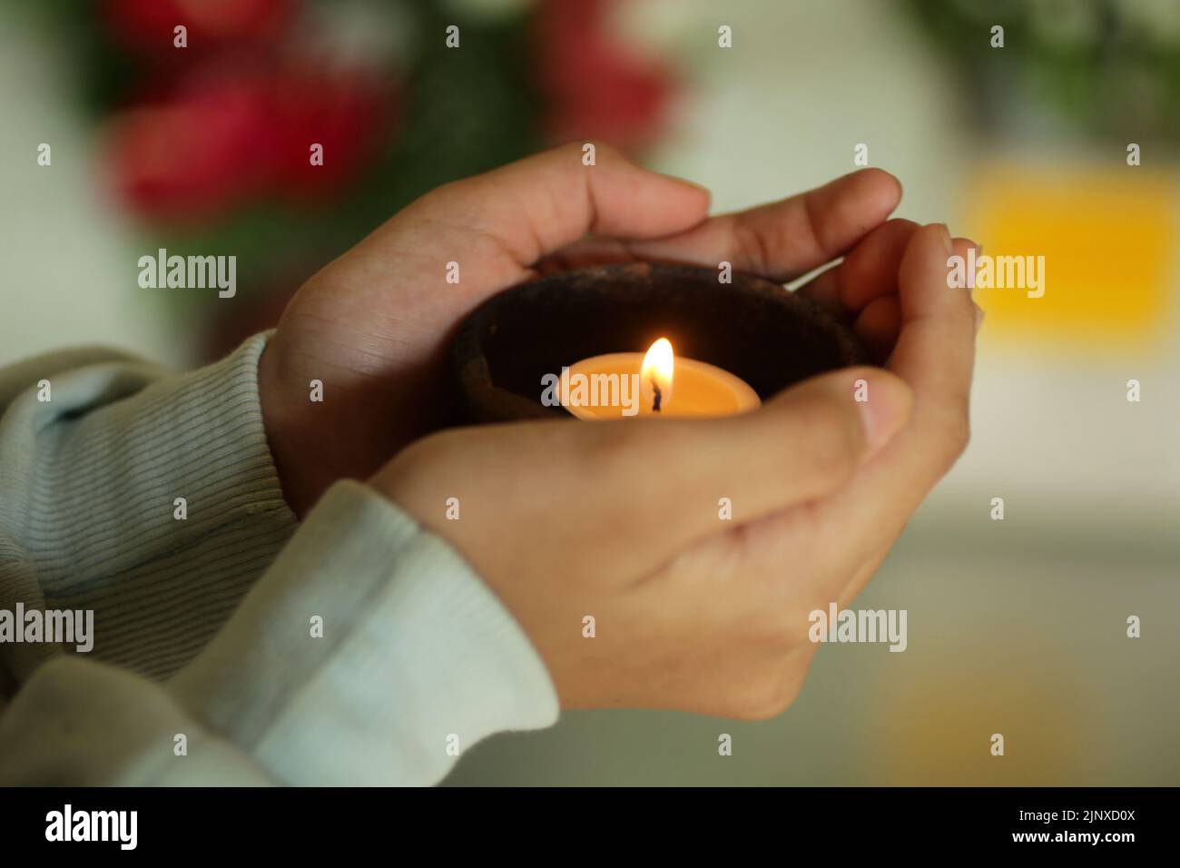 Person holding a candle in hand. Junior girl holding candle light in a ...
