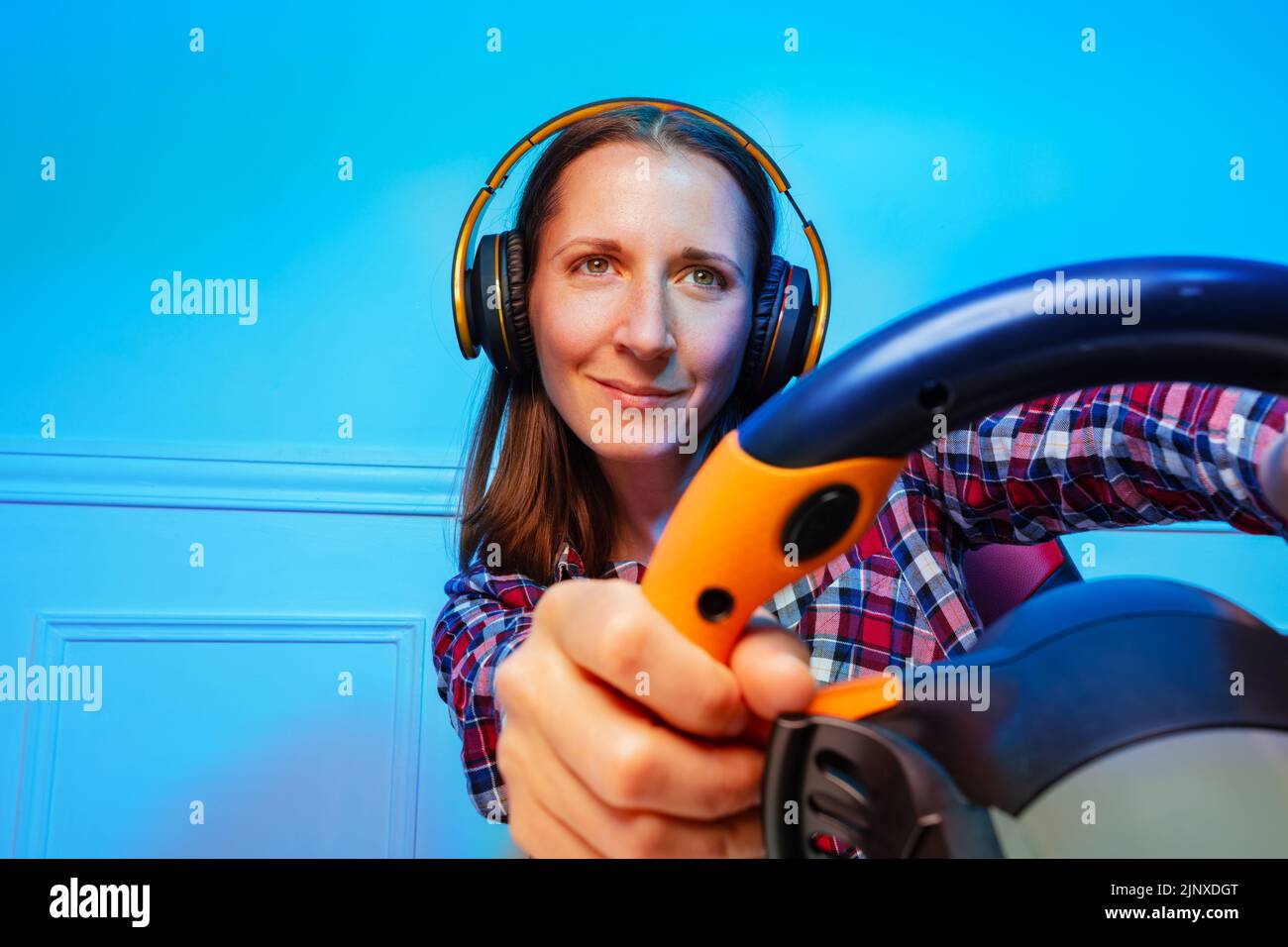 Portrait with console steering wheel of a gamer woman Stock Photo - Alamy