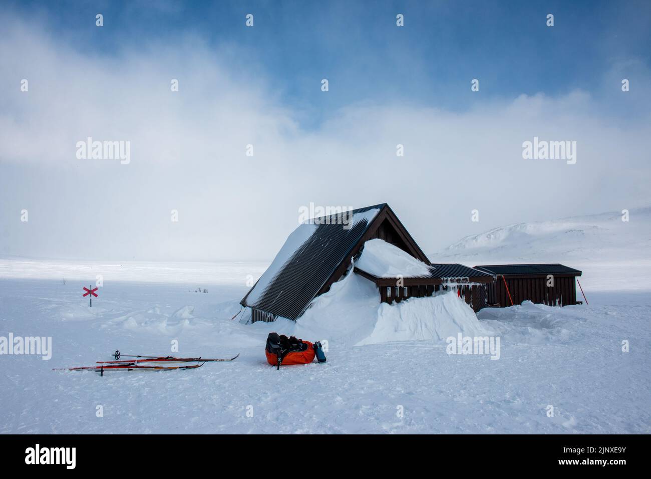 The skies and a backpack near an emergency hut on Kungsleden trail ...