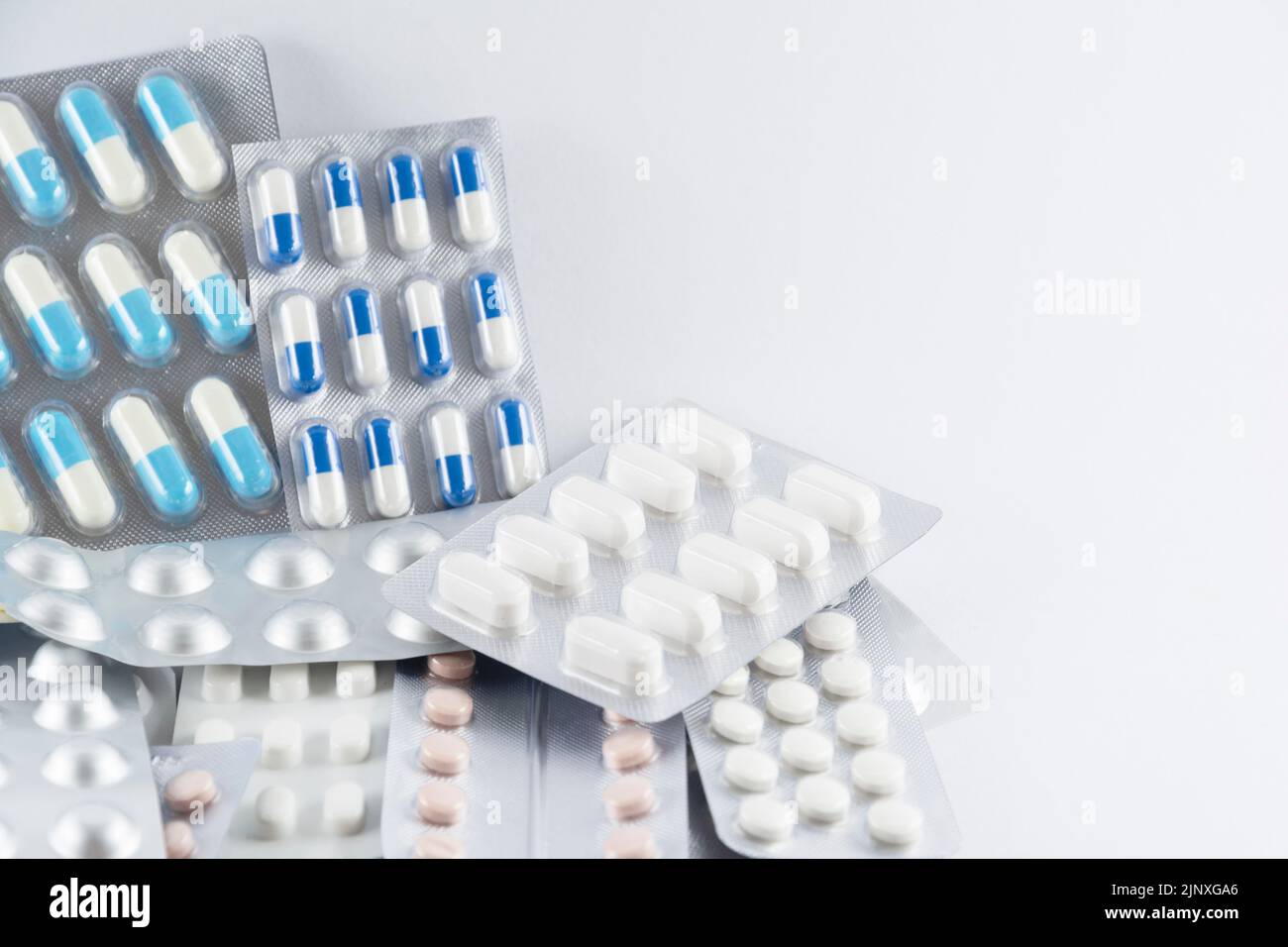 Carton of different pills, medicines, pills stacked on white background ...