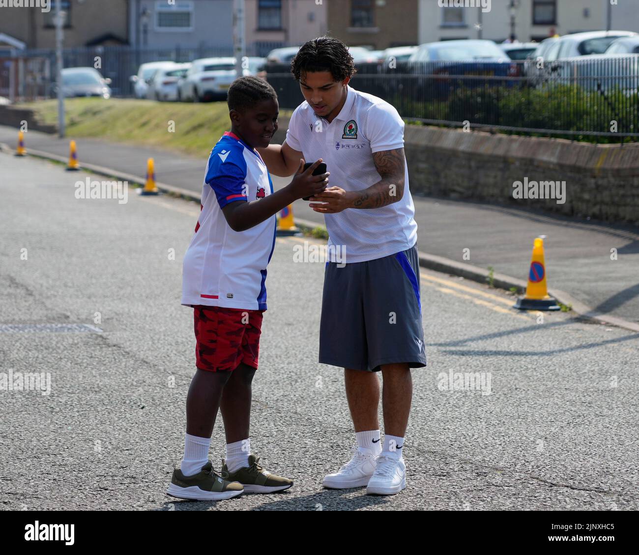 Tyrhys Dolan #10 of Blackburn Rovers poses for a photo with a young fan ...