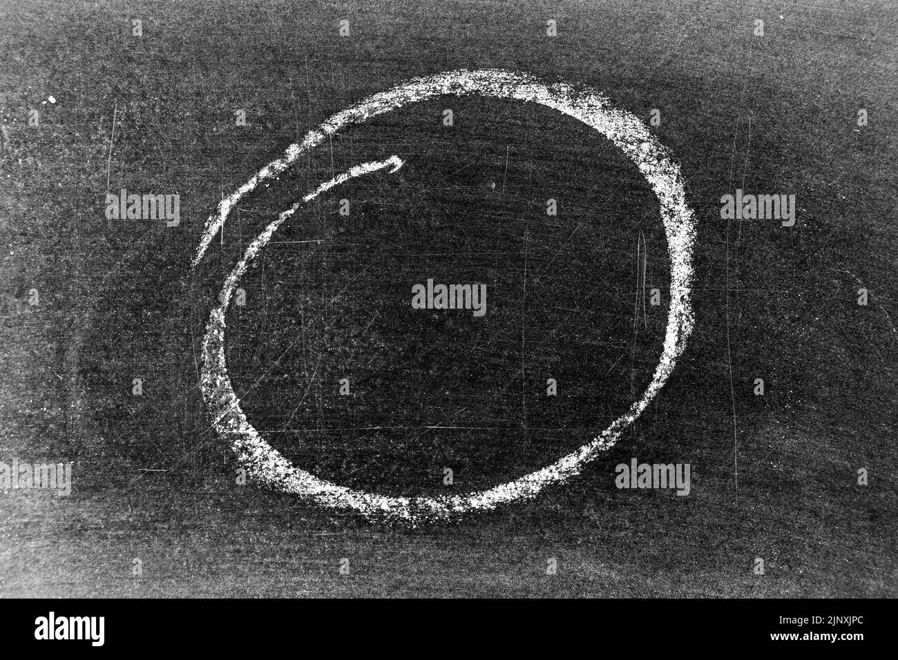 White chalk hand drawing as circle or round shape on blackboard or ...