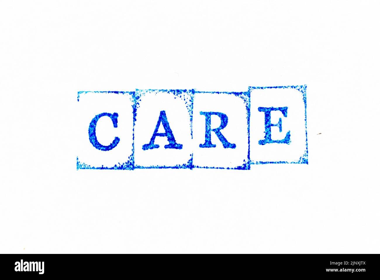 Blue color ink rubber stamp in word care on white paper background ...