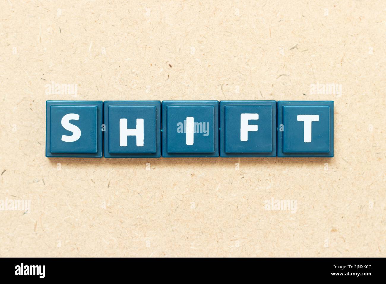 Tile alphabet letter in word shift on wood background Stock Photo - Alamy