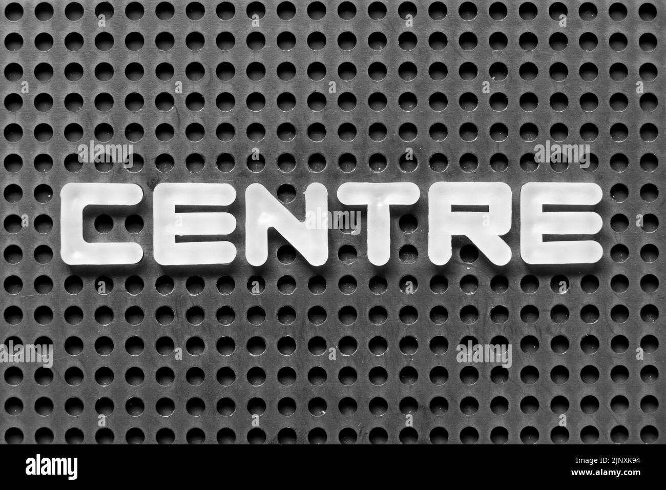 White alphabet letter in word centre on black pegboard background Stock ...