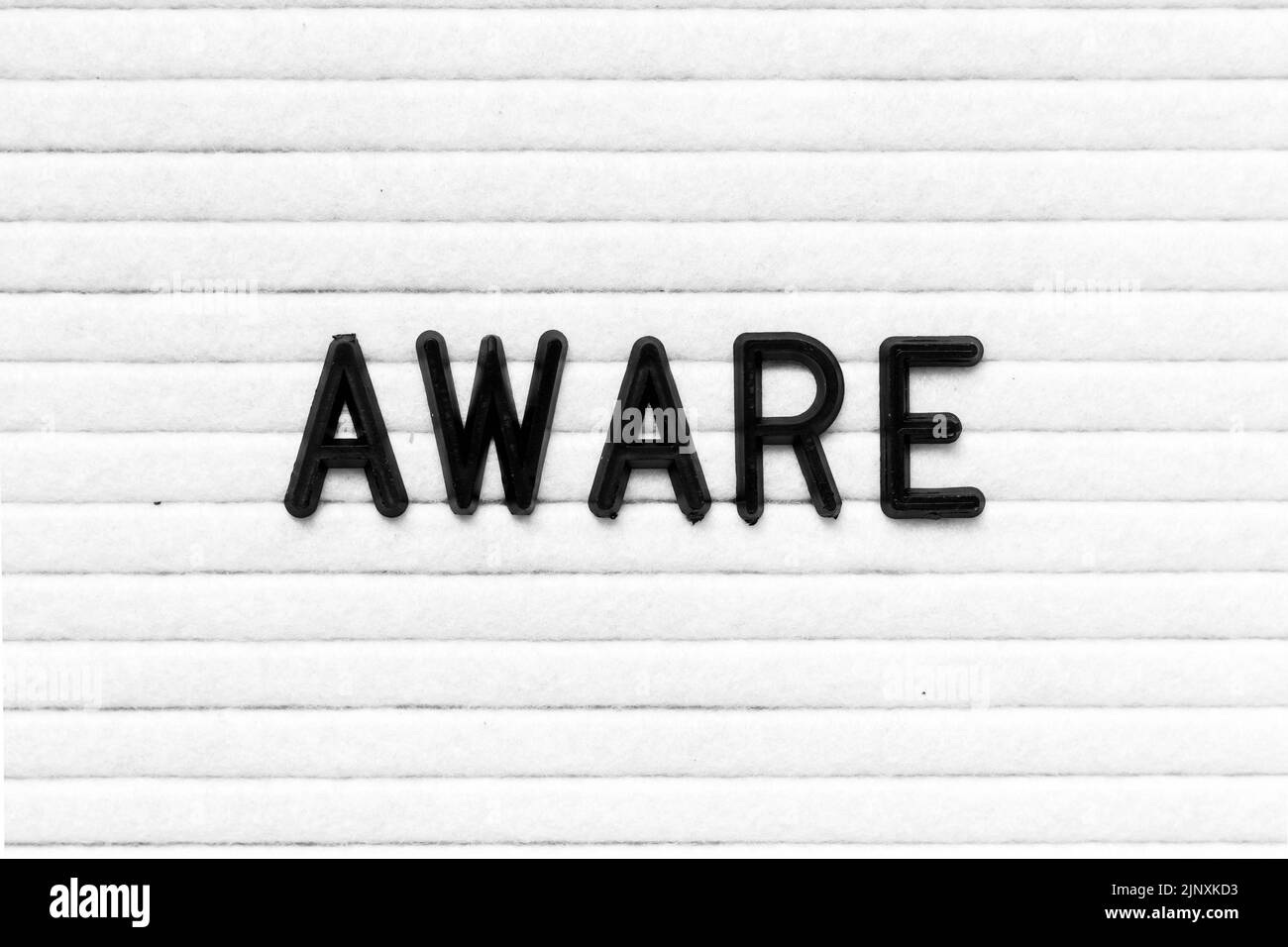 Black color letter in word aware on white felt board background Stock ...