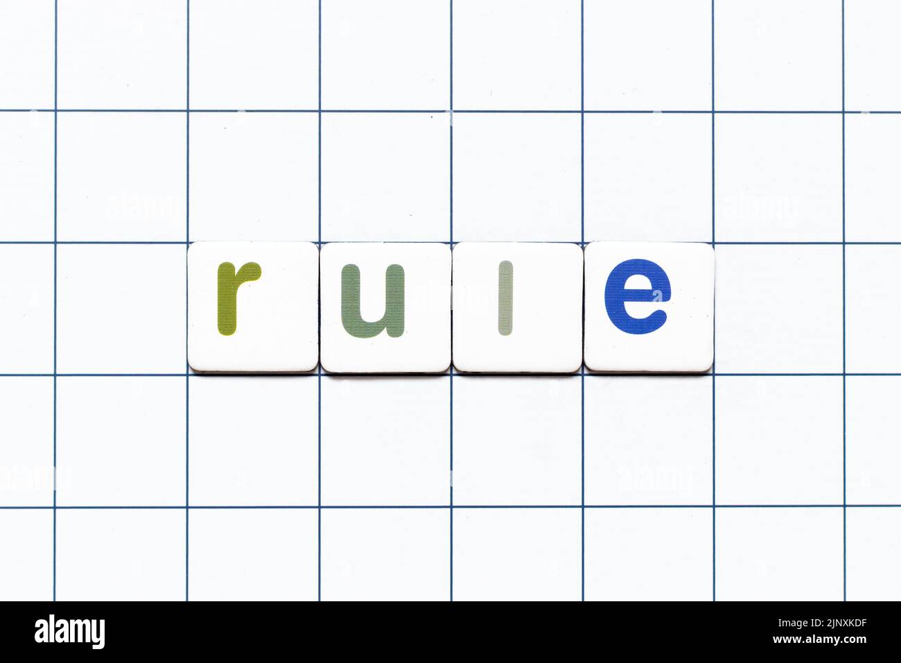 Colorful tile letter in word rule on white grid background Stock Photo ...
