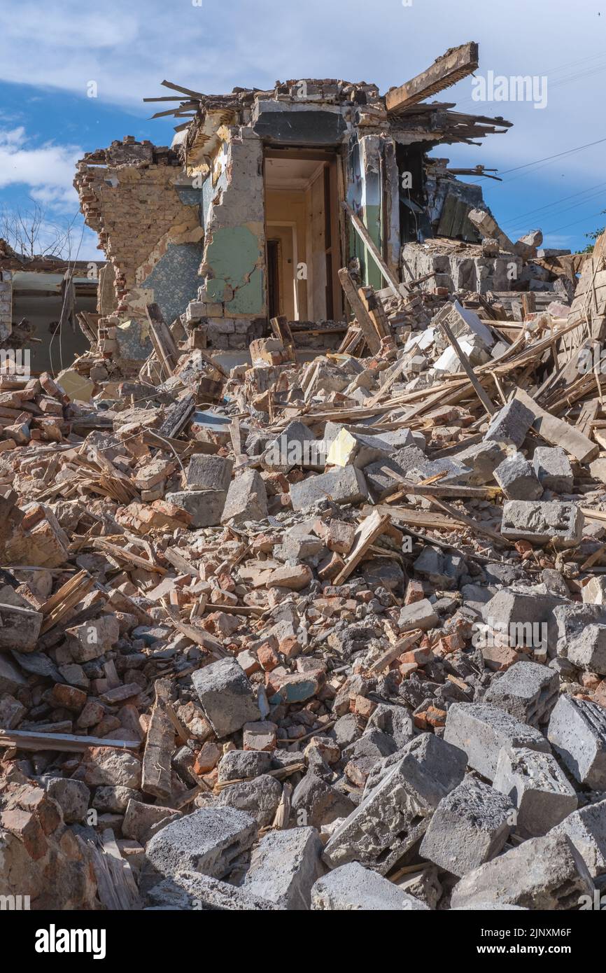 An abandoned house collapses. The house is destroyed. Cracks in wall of ...