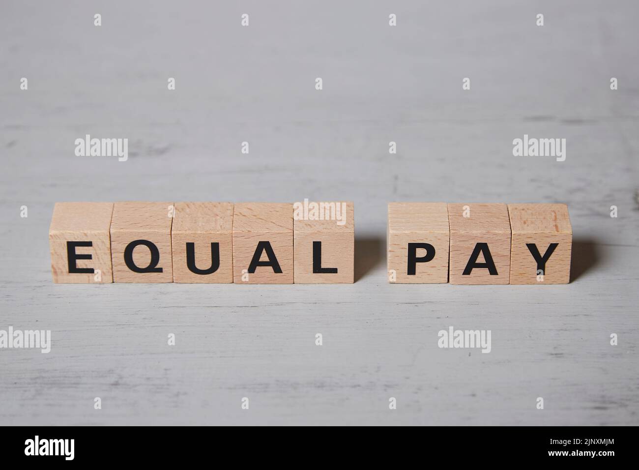 wooden blocks building the word equal pay Stock Photo - Alamy
