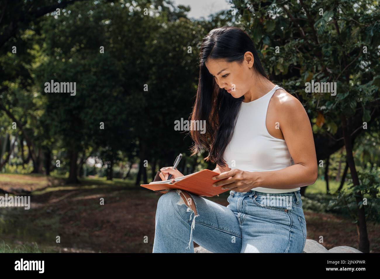 Woman writing in textbook hi-res stock photography and images - Alamy