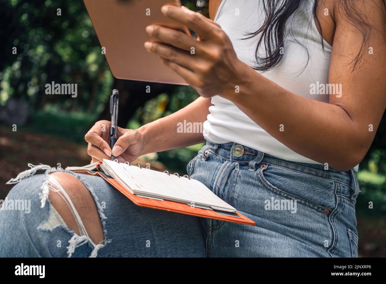 Woman writing in copybook hi-res stock photography and images - Alamy